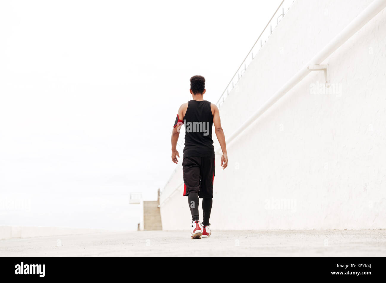 Back view image of young african sports man running outdoors Stock ...