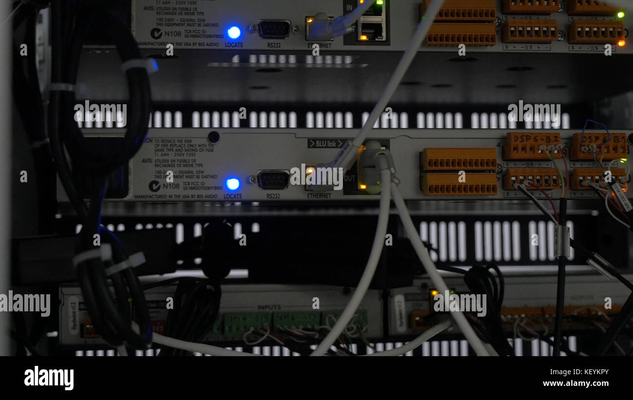 Back of the server installed in the server room. Many cables are ...