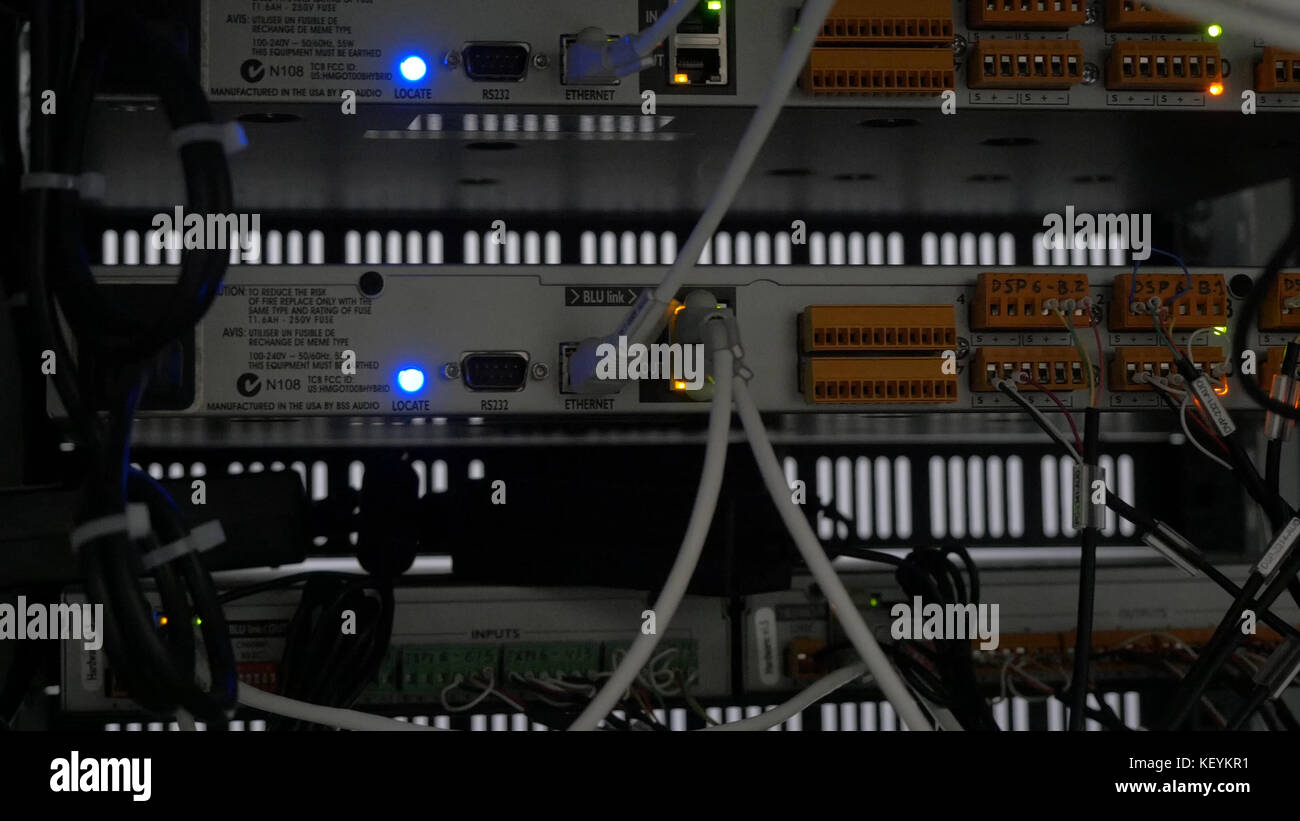 Back of the server installed in the server room. Many cables are ...