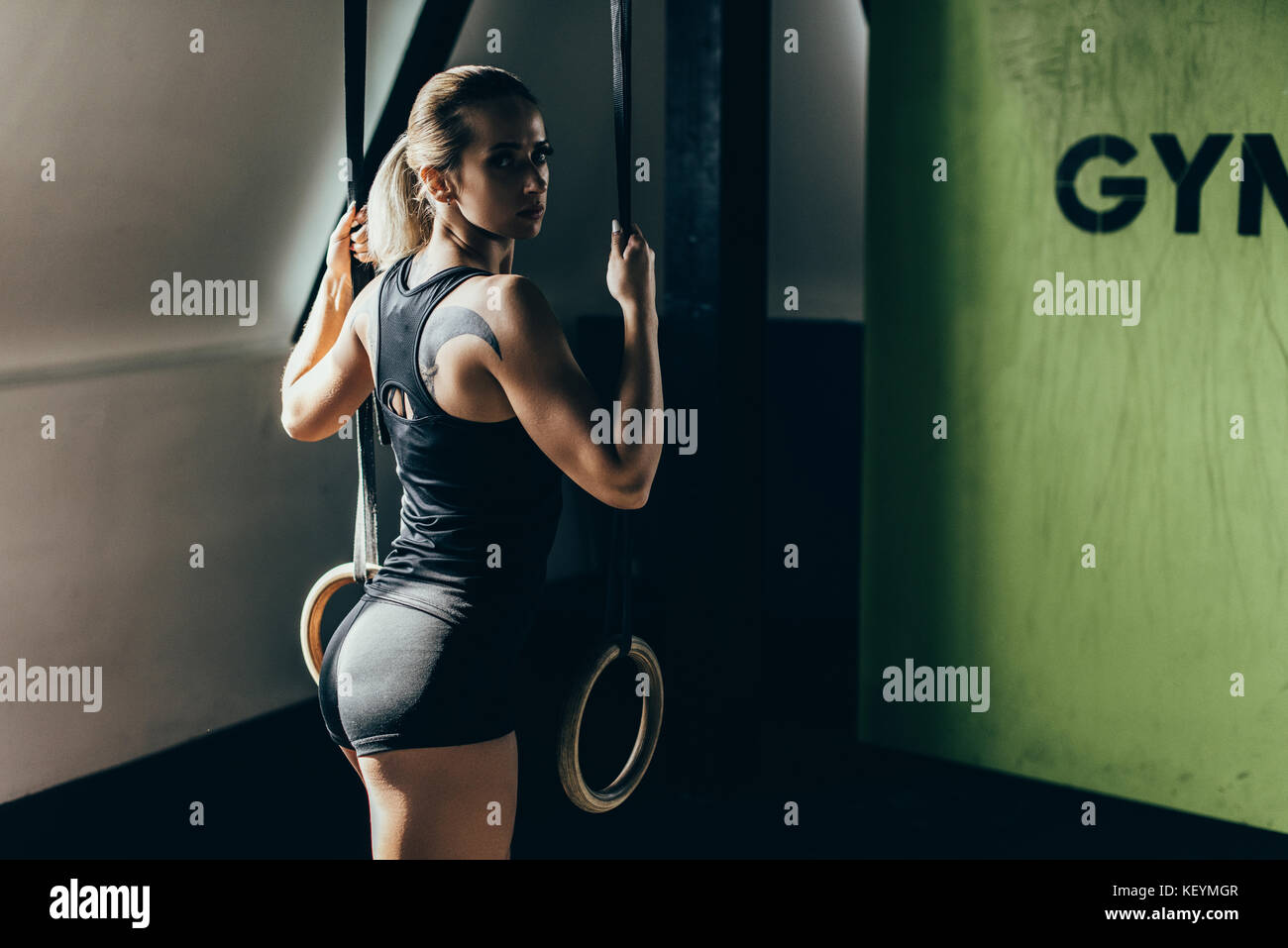 Woman posing with gymnastic rings Stock Photo - Alamy