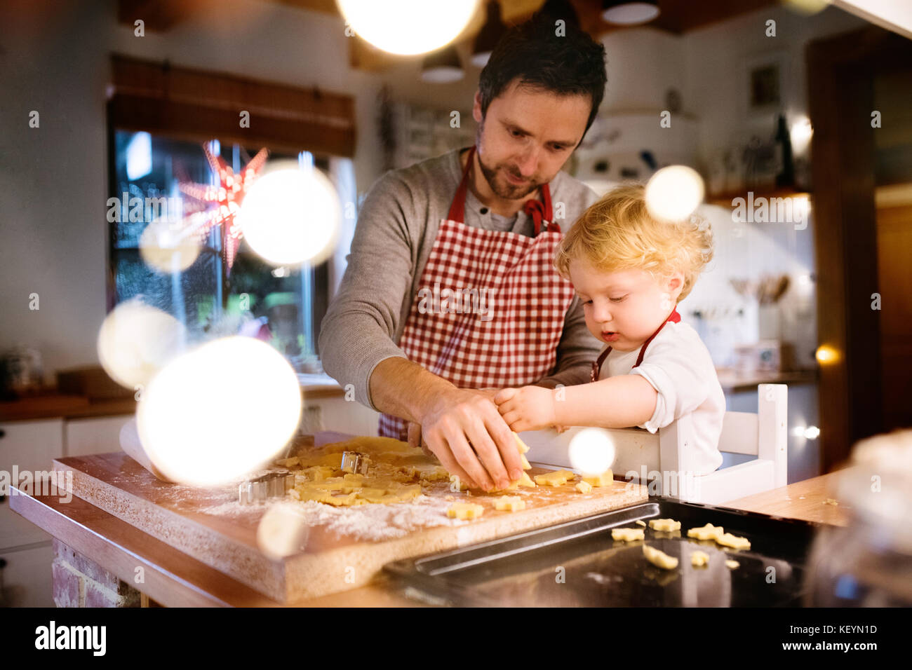 Man and toddler boy making cookies at home. Father and son baking ...