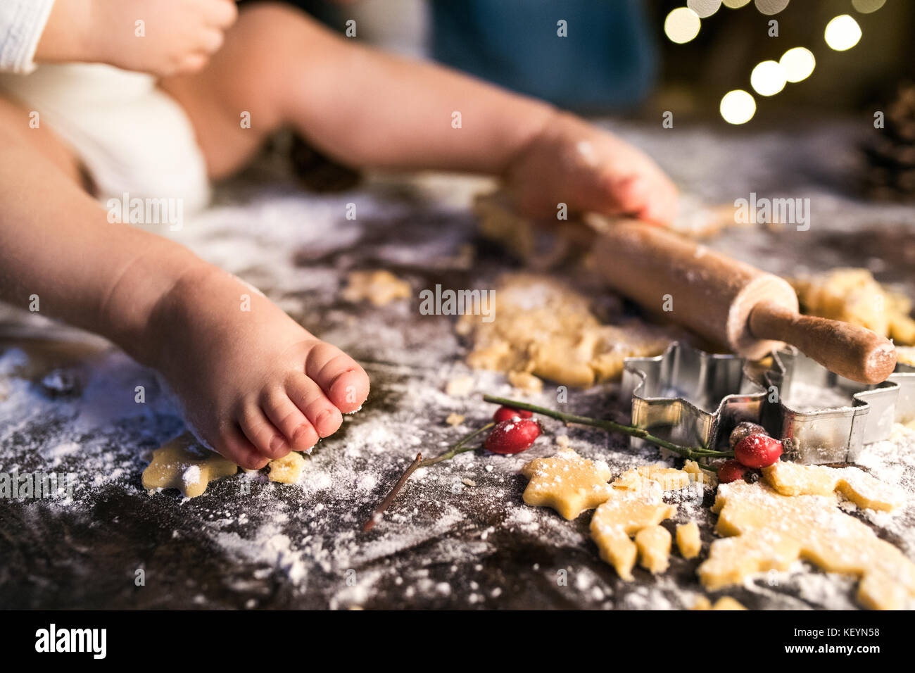 Young family making gingerbread cookies at home. Unrecognizable little ...