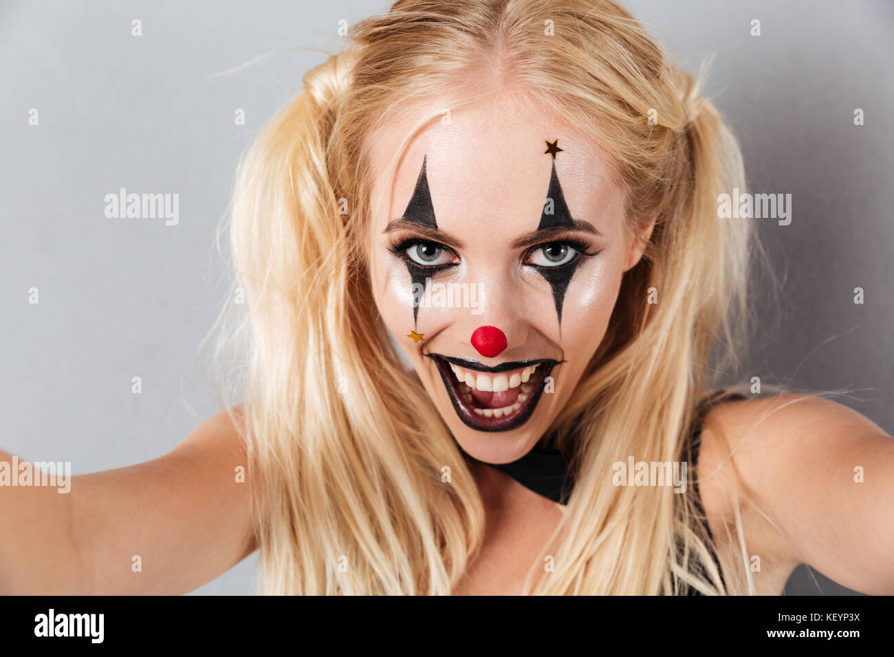 Close up portrait of a pretty smiling blonde woman in bright halloween ...