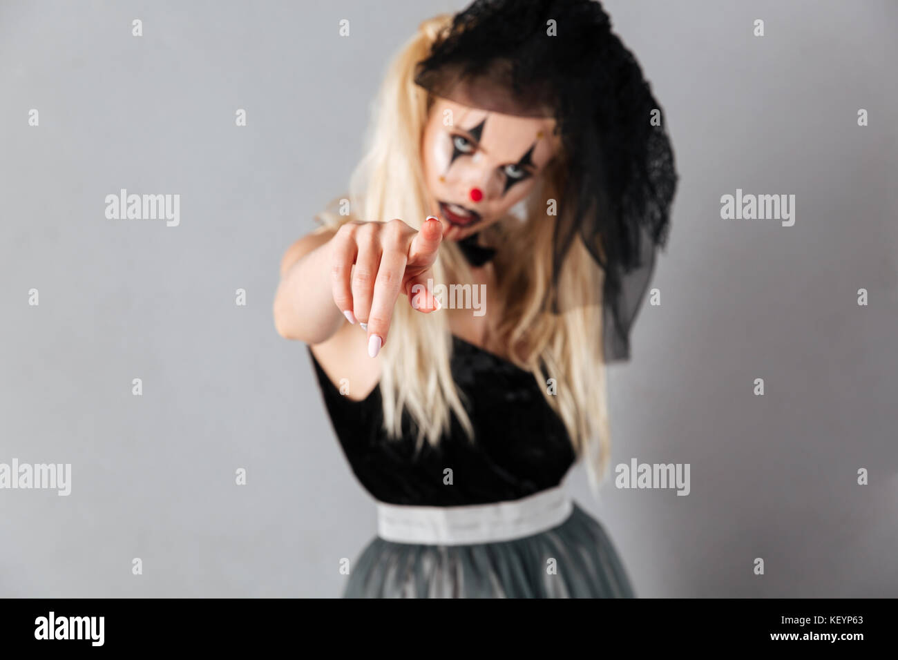 Scary spooky blonde woman dressed in black widow halloween costume ...