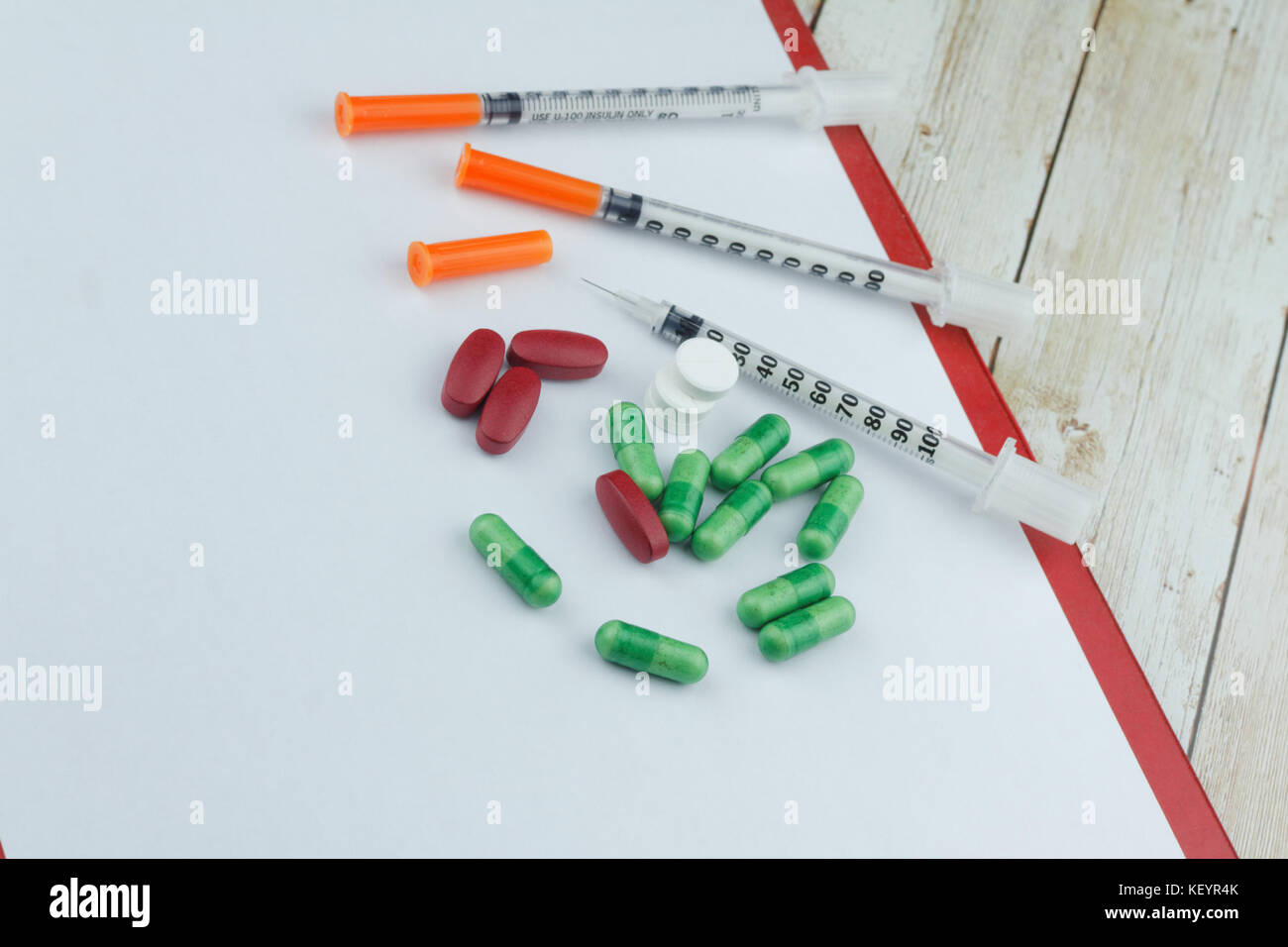 Healthcare concept. Capsule,caplet,tablet and syringe on isolated white ...