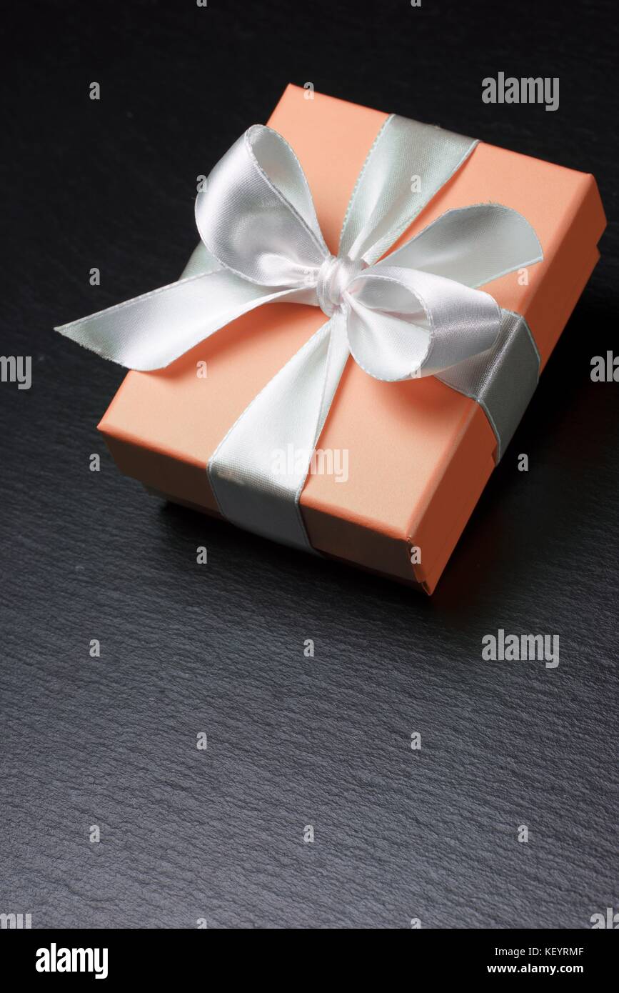 Luxury box tied with a white ribbon Stock Photo - Alamy