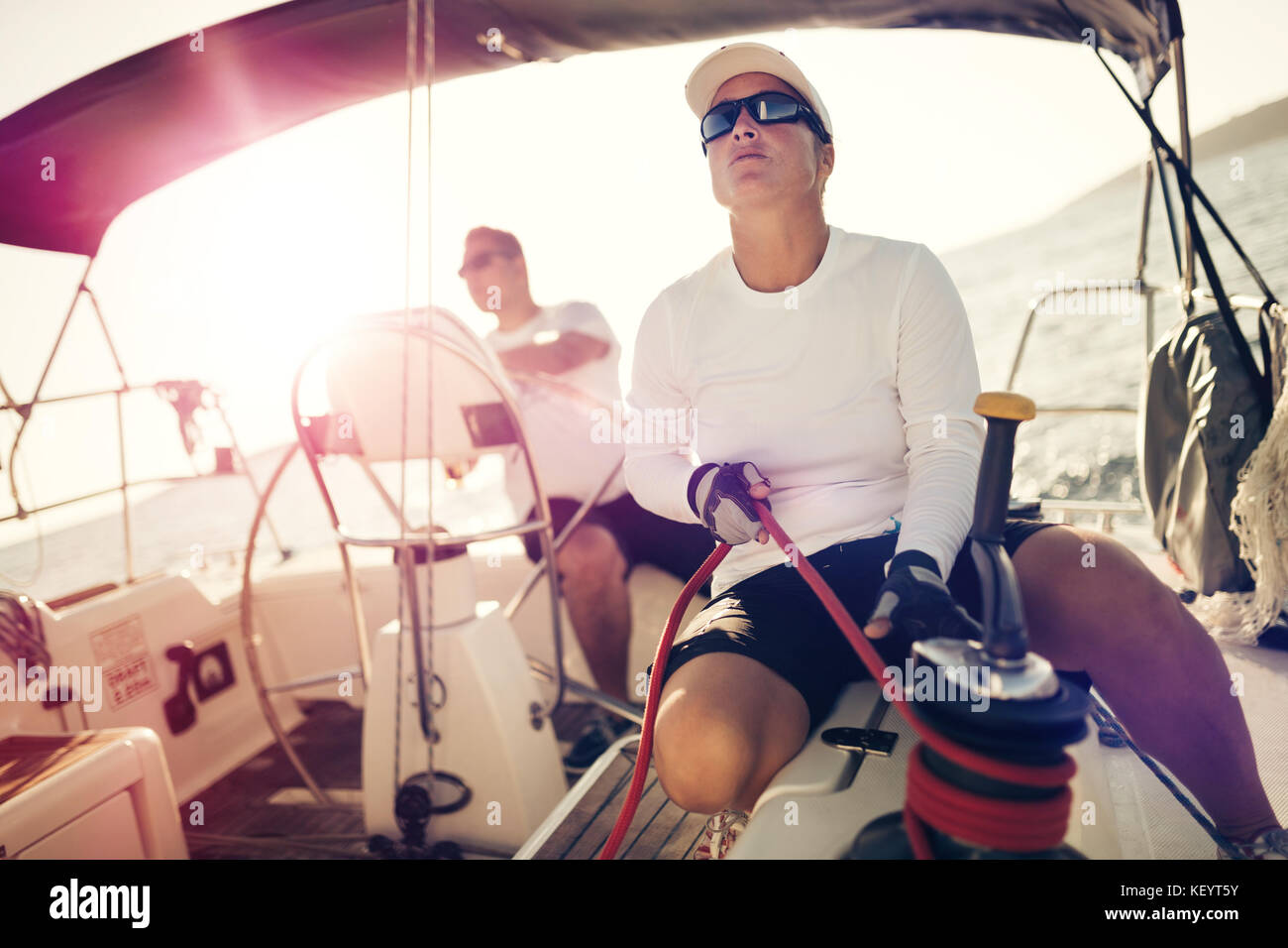 Attractive strong woman sailing with her boat Stock Photo - Alamy