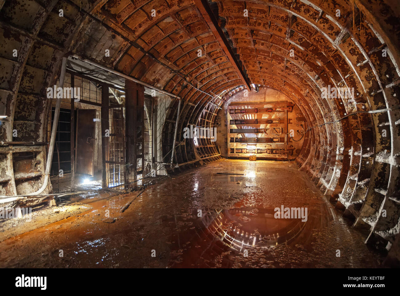 A huge rusty armored protective iron gate with an electric drive. The ...