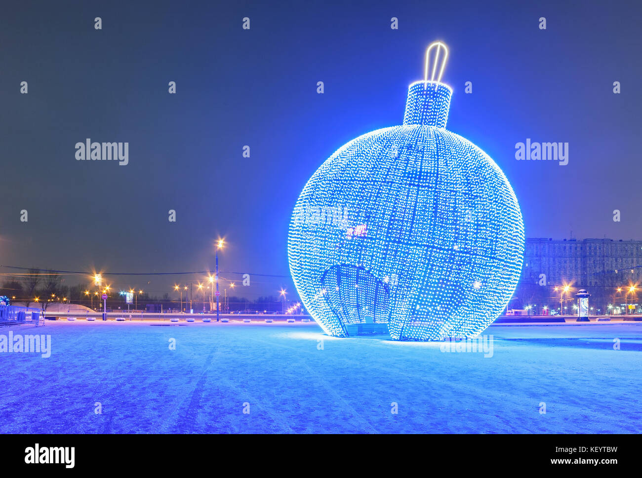 Giant glowing blue Christmas ball on the street with snow Stock Photo ...