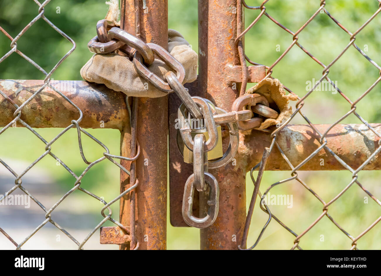 barred gate with fence detail in sunny ambiance Stock Photo - Alamy