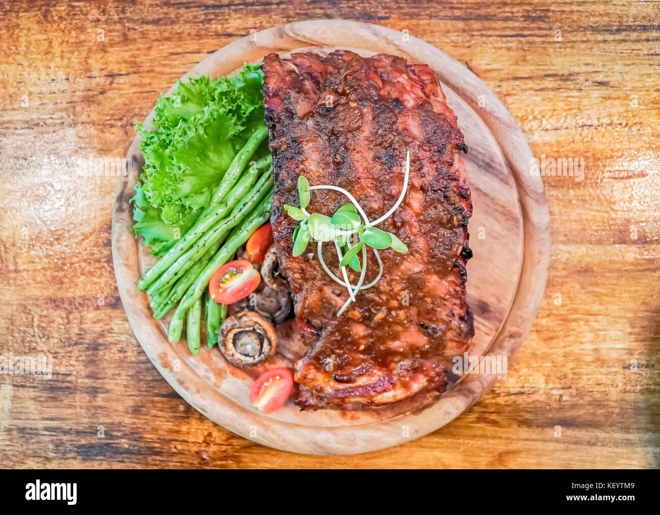 Tasty grilled ribs with vegetables Stock Photo - Alamy