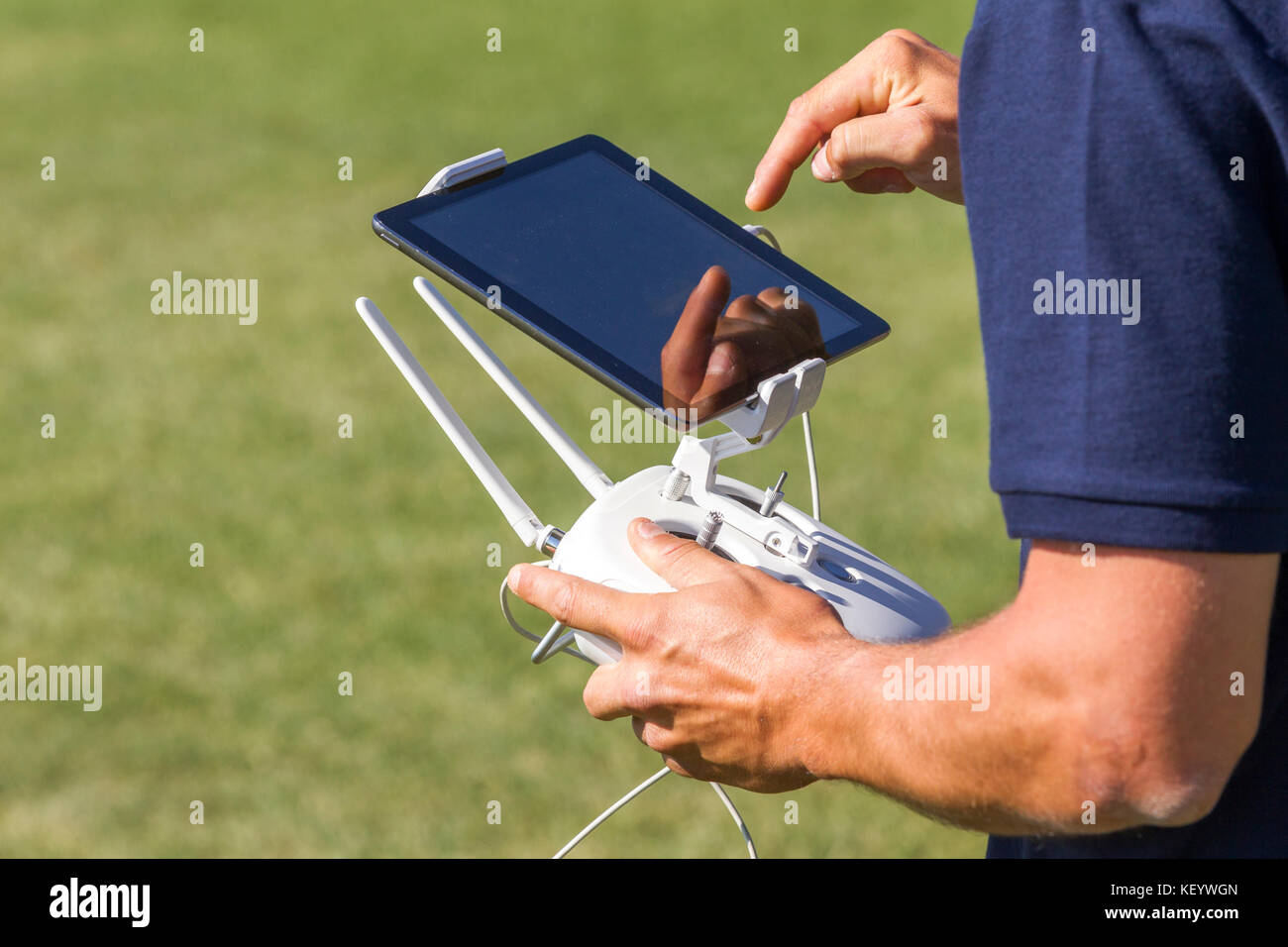A man handle remote control of drone during capturing photos and video ...