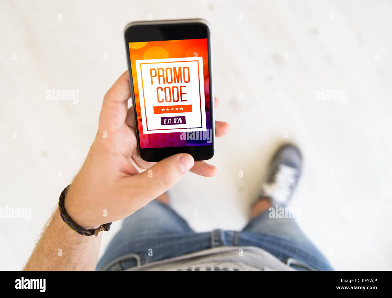 close up of male hand using promo code smart phone Stock Photo - Alamy