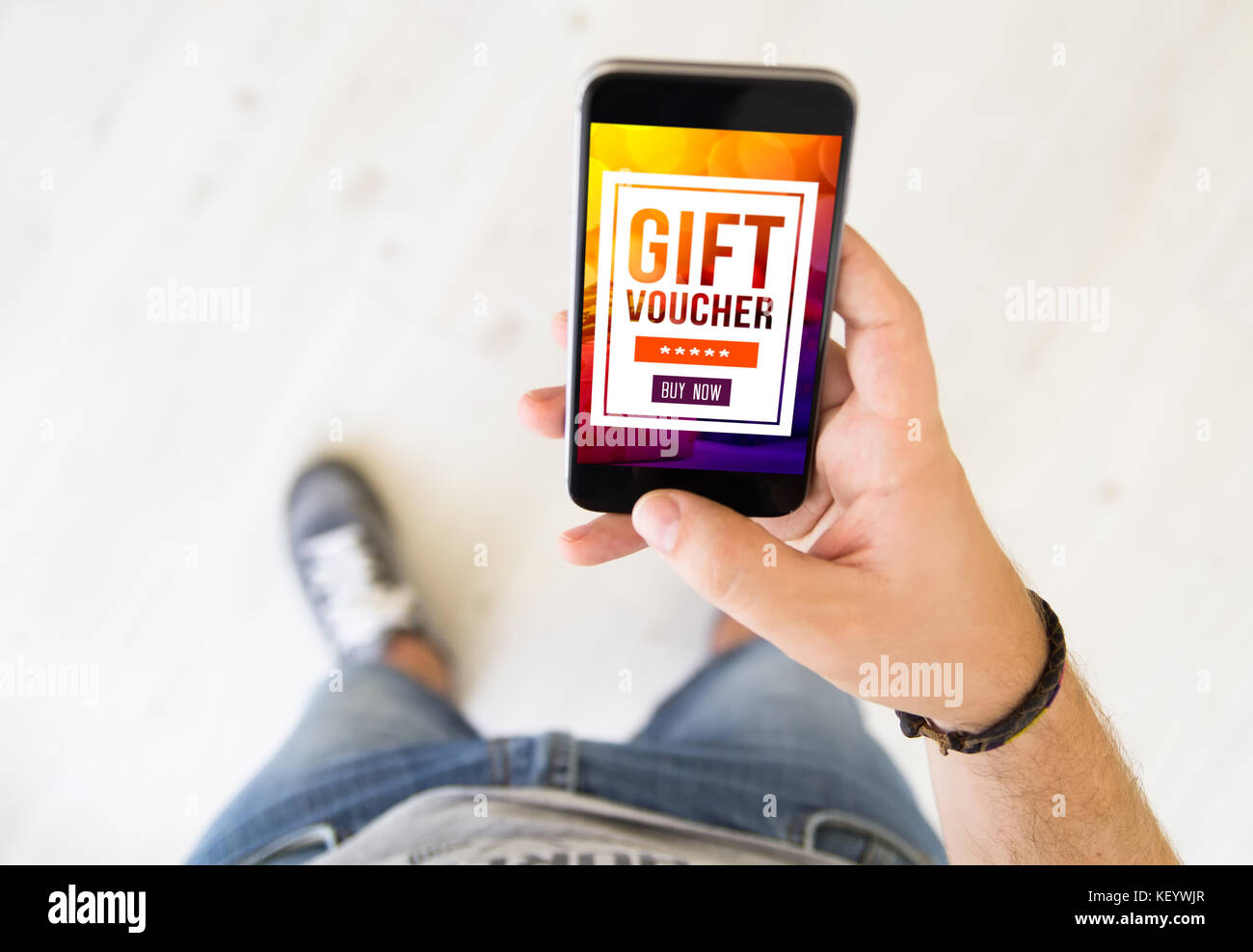 close up of male hand using gift voucher smart phone Stock Photo - Alamy