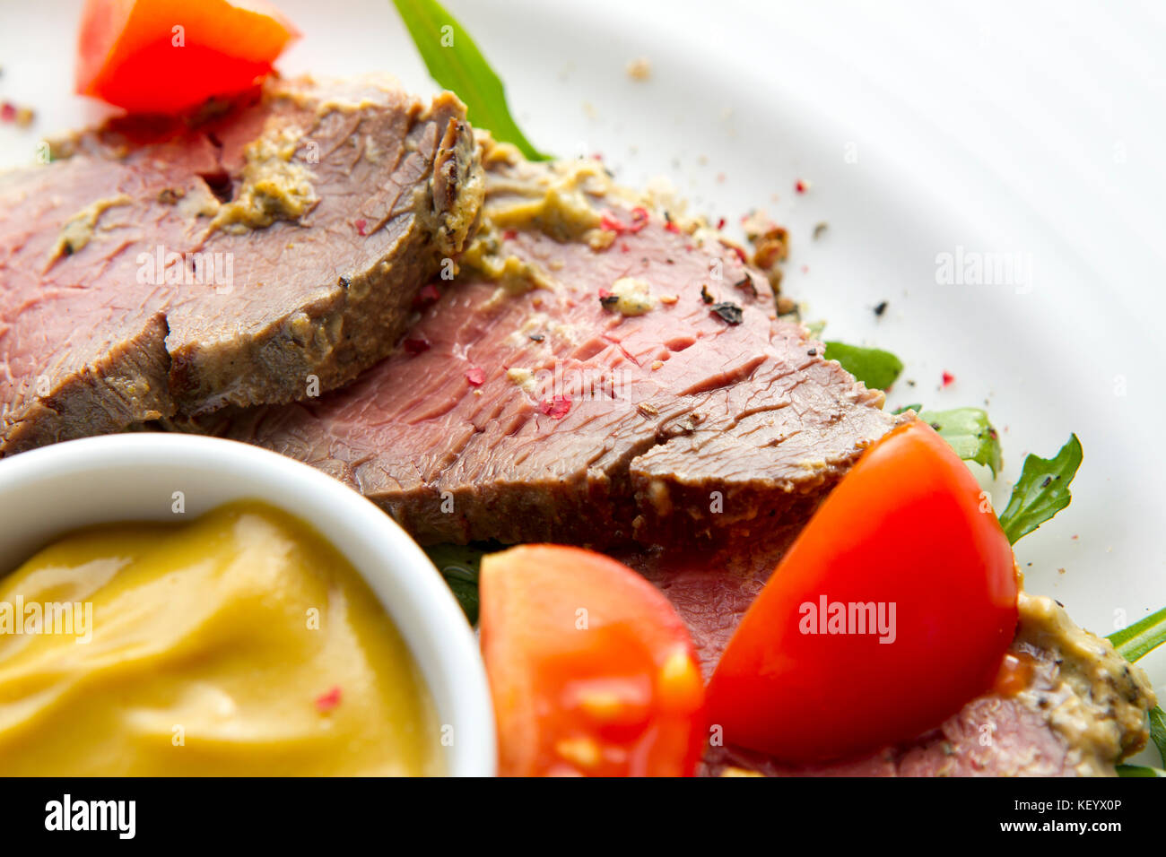 Closeup of roast beaf with honey mustard and vegetables Stock Photo - Alamy