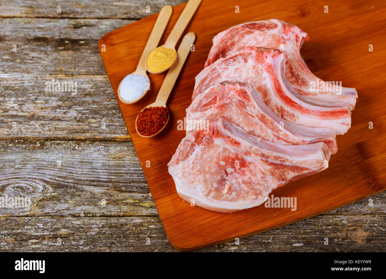 fresh raw pork loin with bay leaf on wooden board and on the background ...
