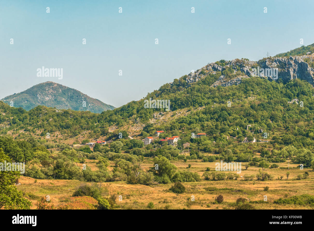 A small village and buildings in the green Balkan mountains of ...