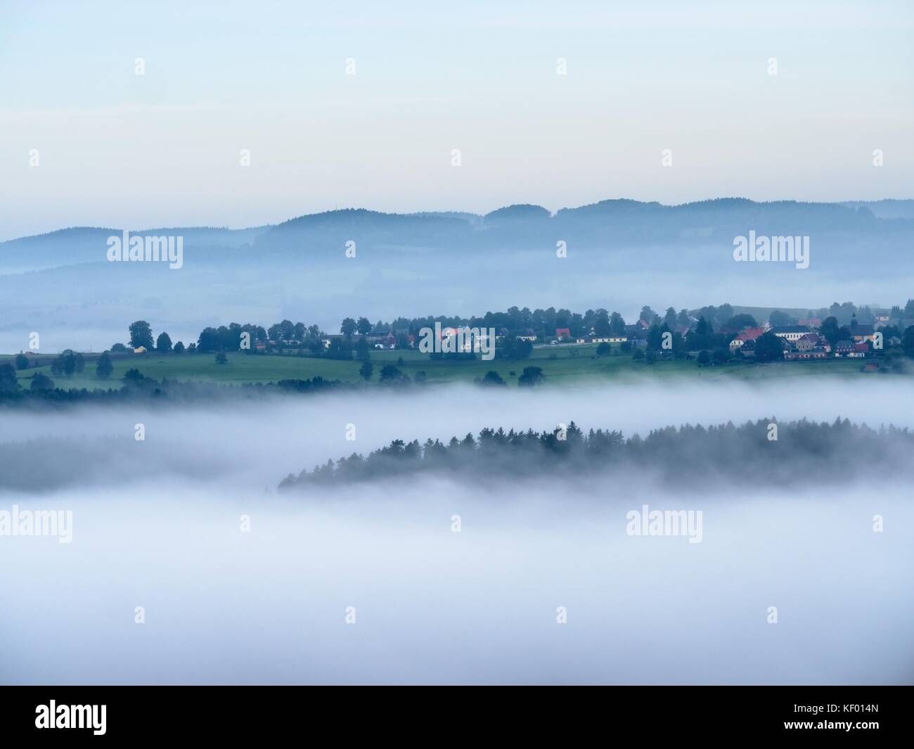 Autumn inversion fog. Peaks of hills increased from foggy background ...