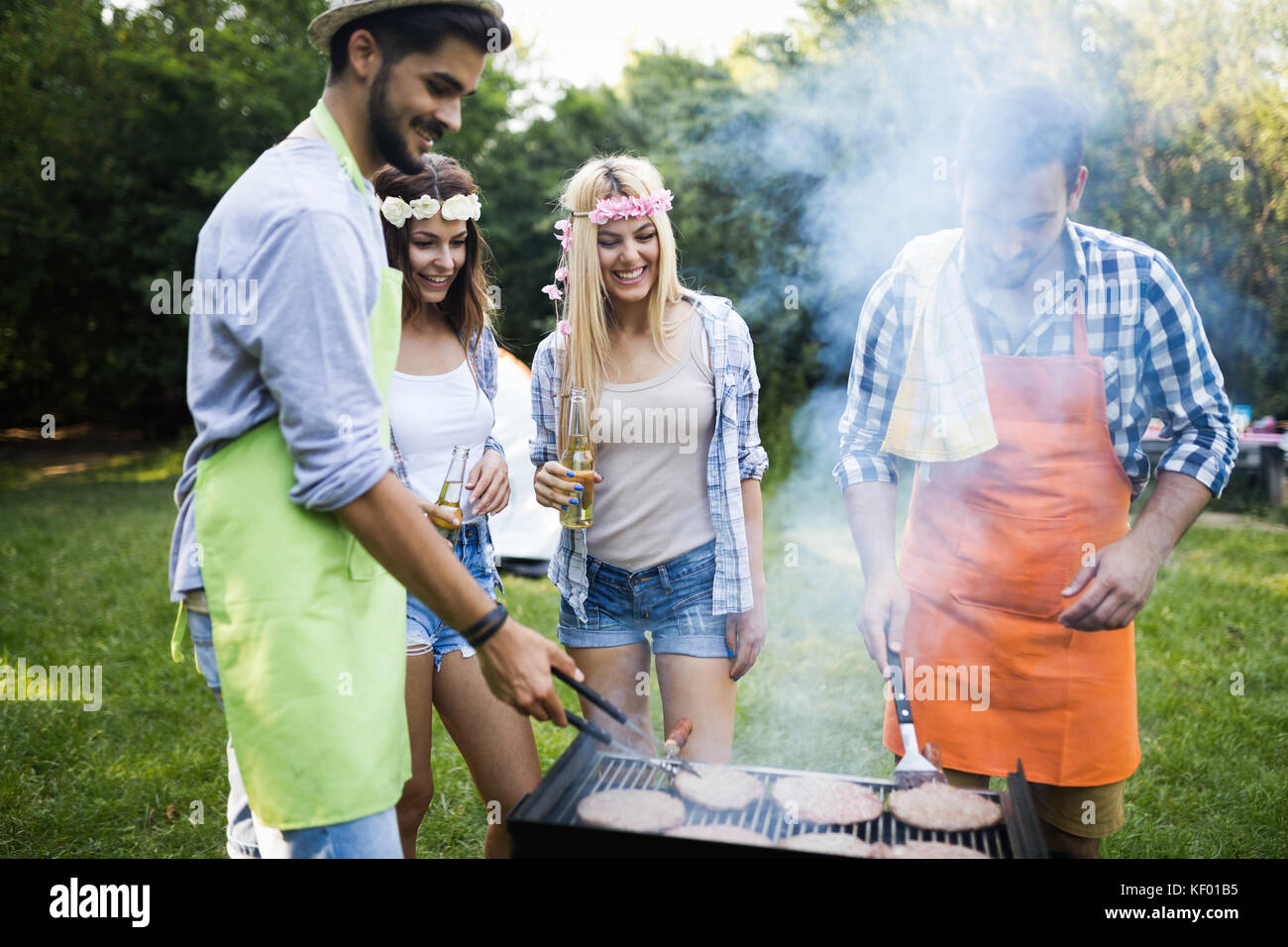 Friends spending time in nature and having barbecue Stock Photo - Alamy