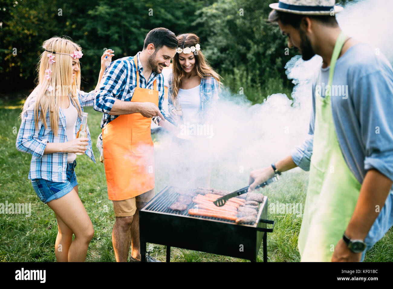 Friends spending time in nature and having barbecue Stock Photo - Alamy