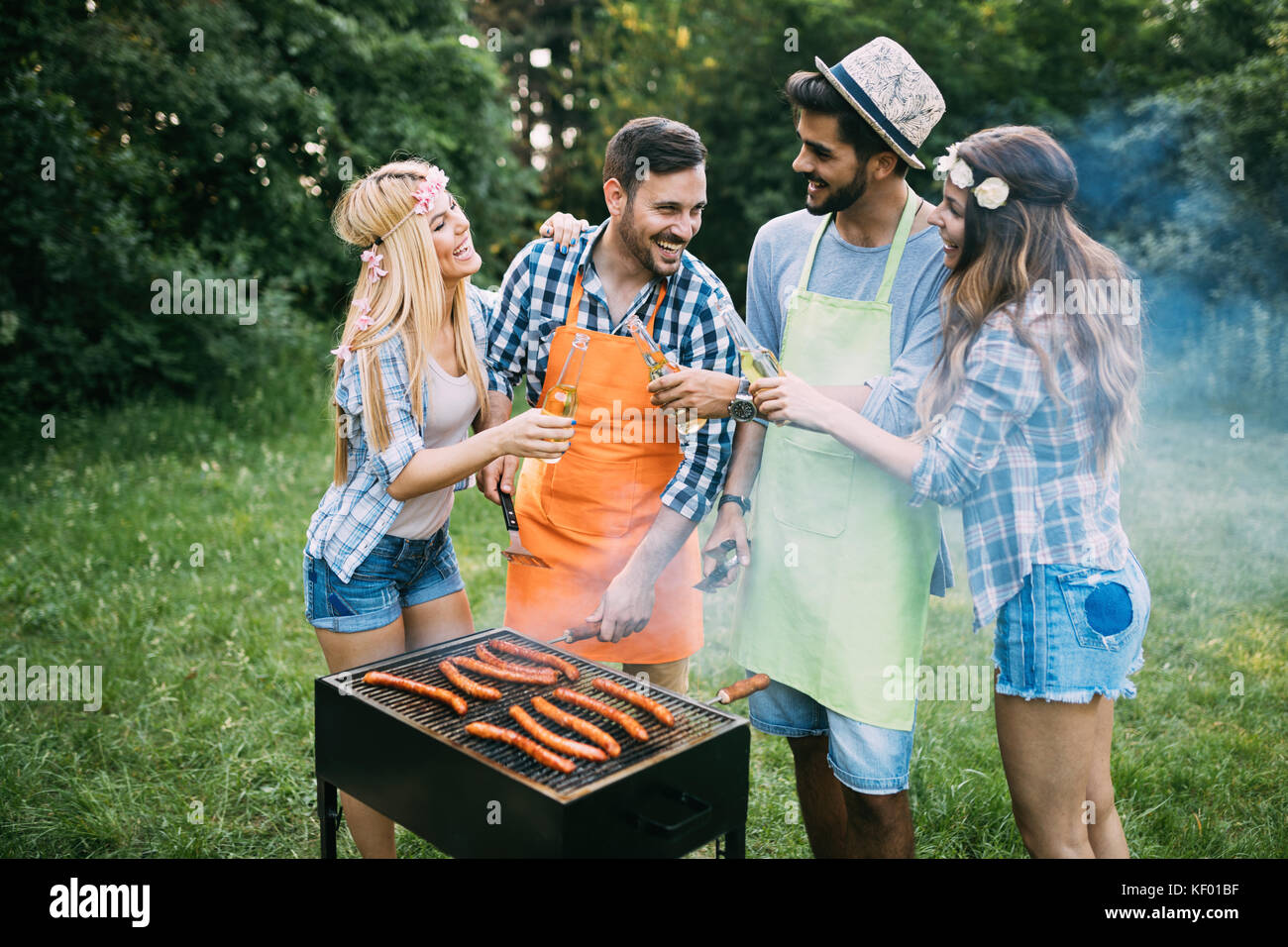 Friends spending time in nature and having barbecue Stock Photo - Alamy