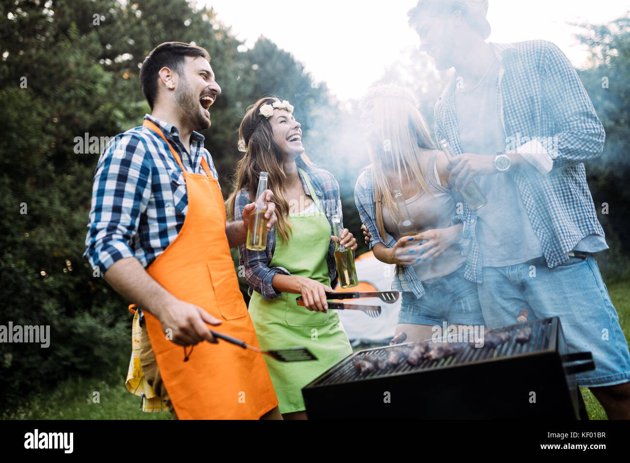 Friends spending time in nature and having barbecue Stock Photo - Alamy