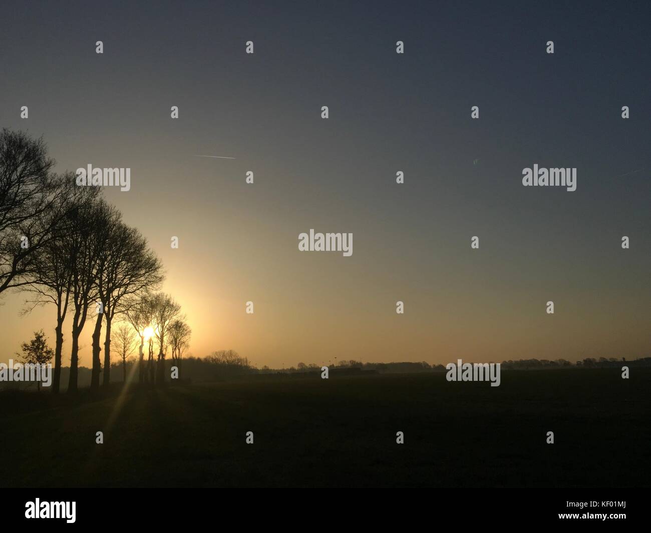 Dramatic golden sunrise over a lovely green natural landscape with ...