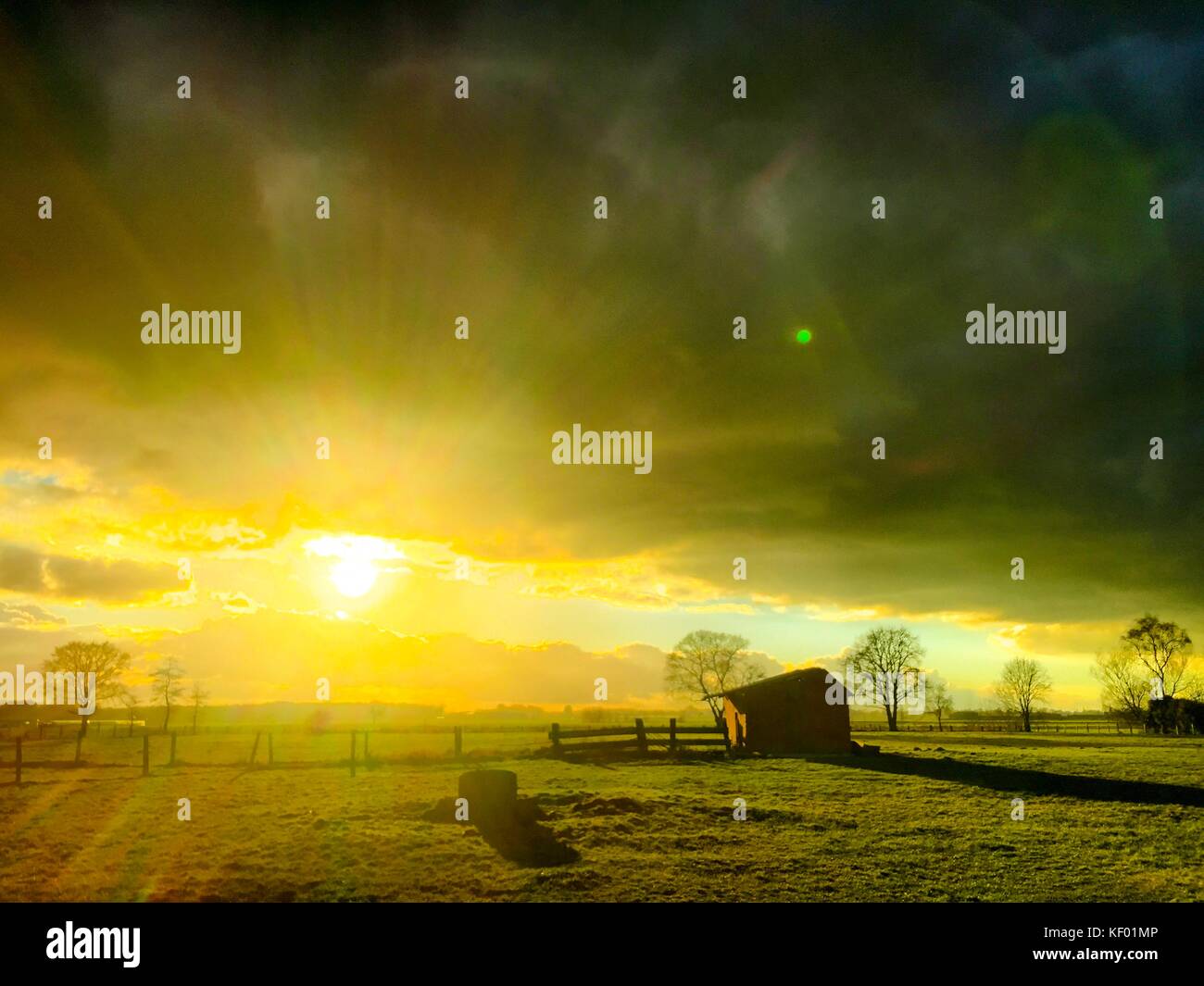 Dramatic golden sunrise over a lovely green natural landscape with ...