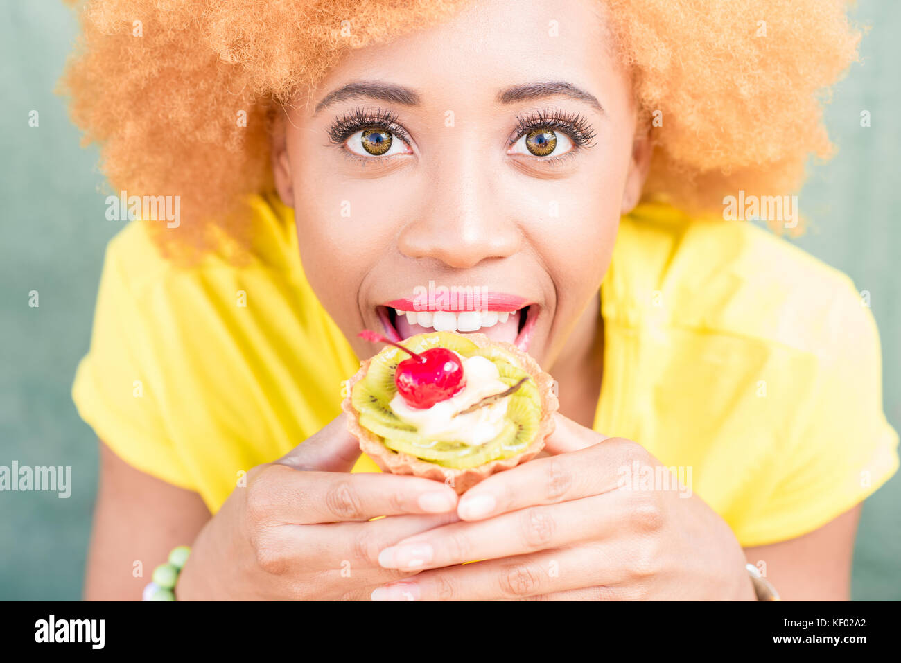 Colorful portrait of an african woman with sweet dessert Stock Photo ...