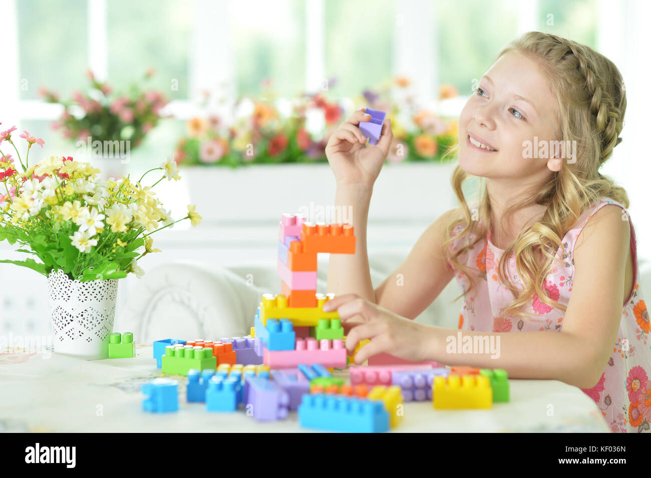 little girl with colorful plastic blocks Stock Photo - Alamy