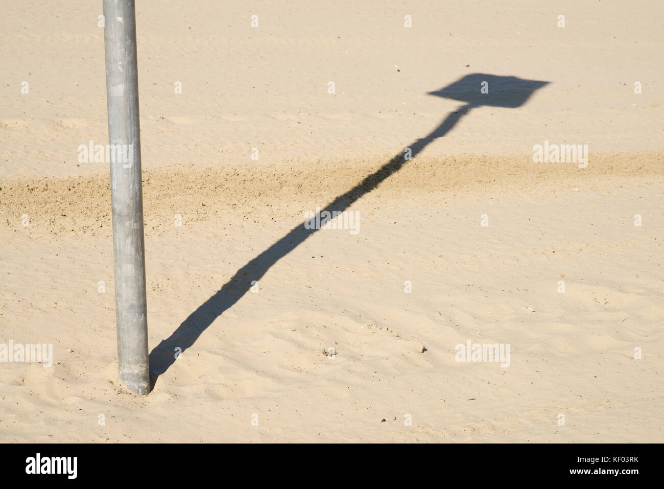 Pole and shadow on the beach Stock Photo - Alamy