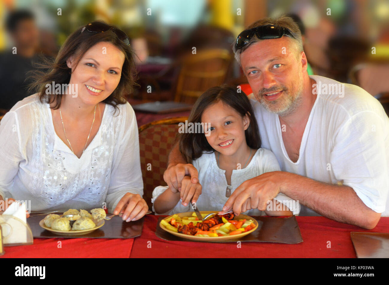 smiling family eating at cafe Stock Photo - Alamy