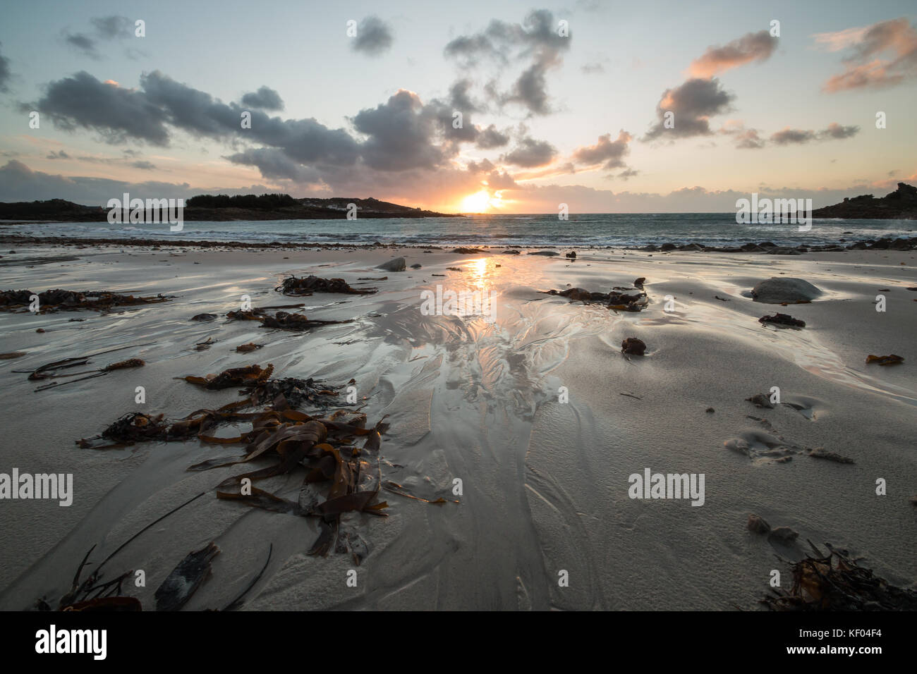 Sunset reflected in sand patterns from Porthloo beach, Isles of Scilly ...