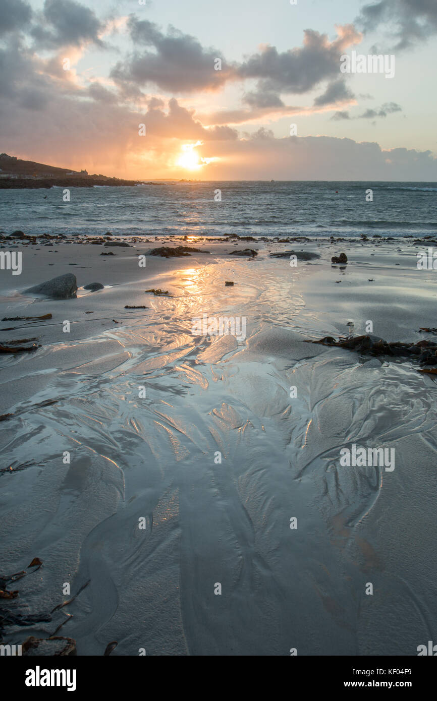 Sunset reflected in sand patterns from Porthloo beach, Isles of Scilly ...