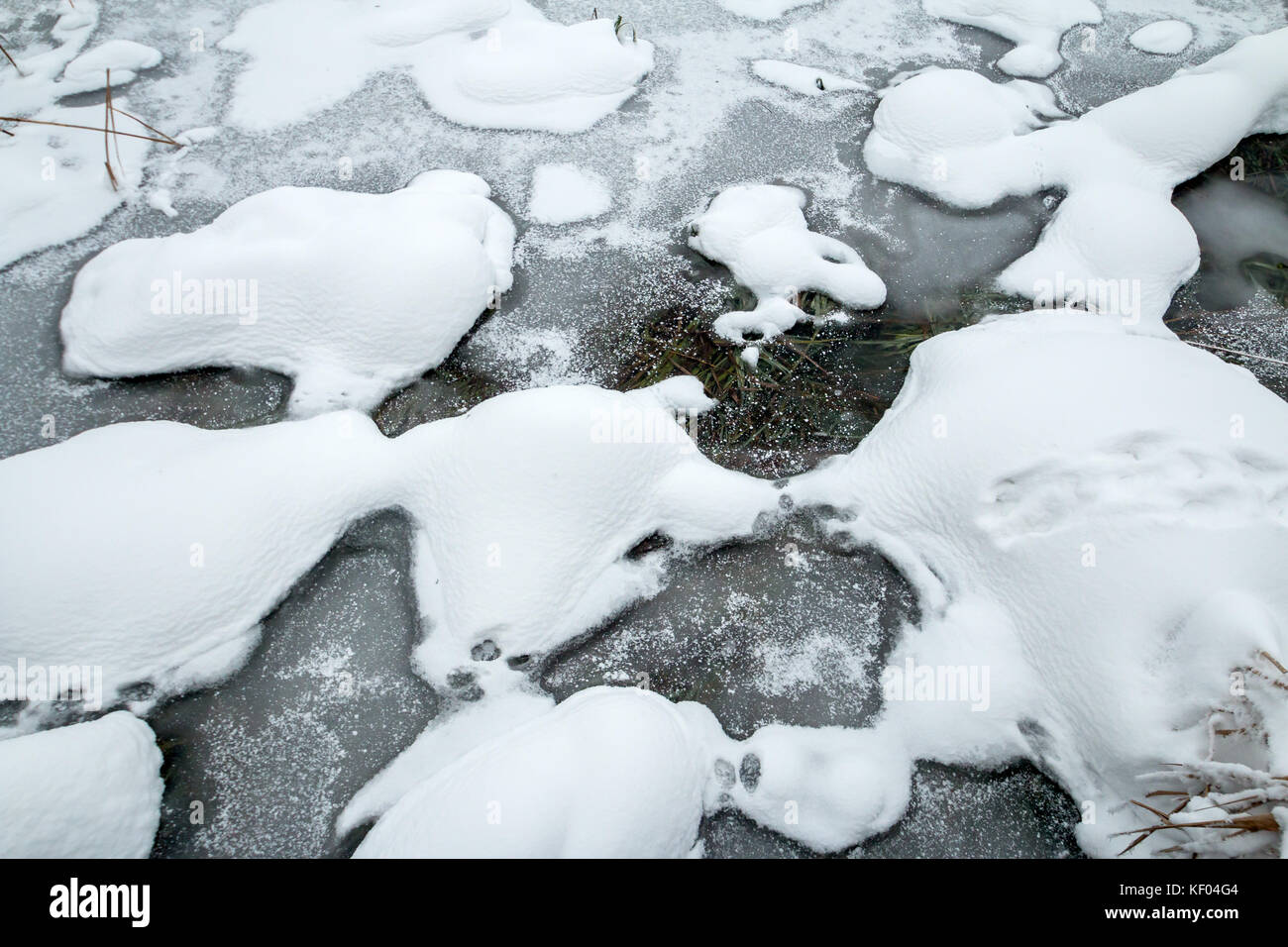 Patchy snow sits on a frozen lake, Plitvice Lakes National Park ...