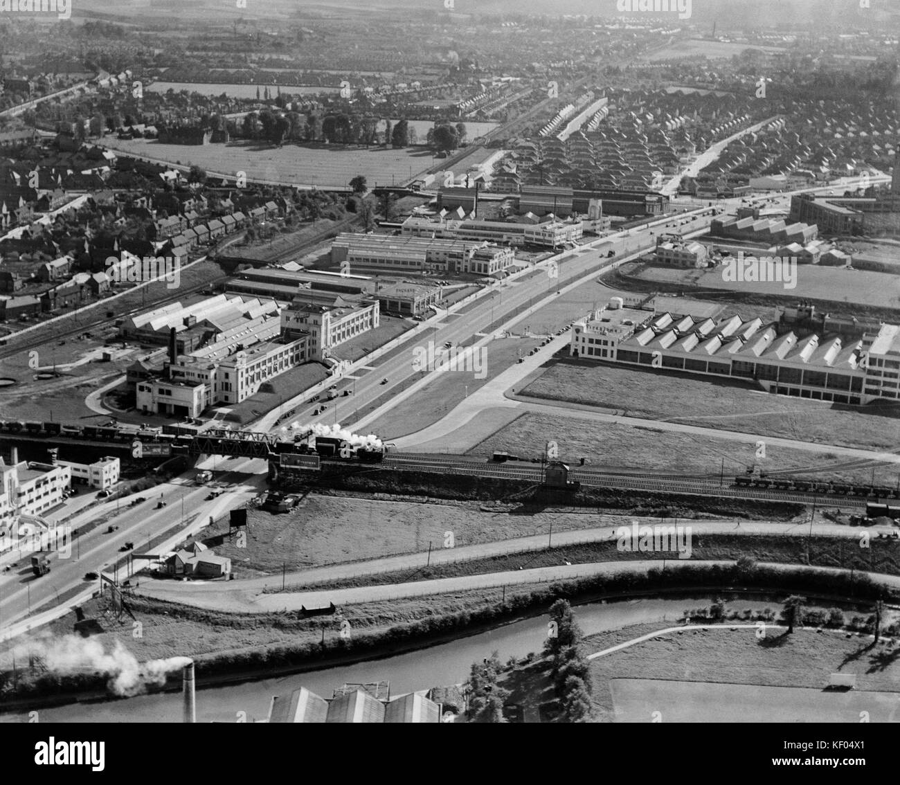 Great West Road, Brentford, Middlesex. A steam train crosses a railway ...