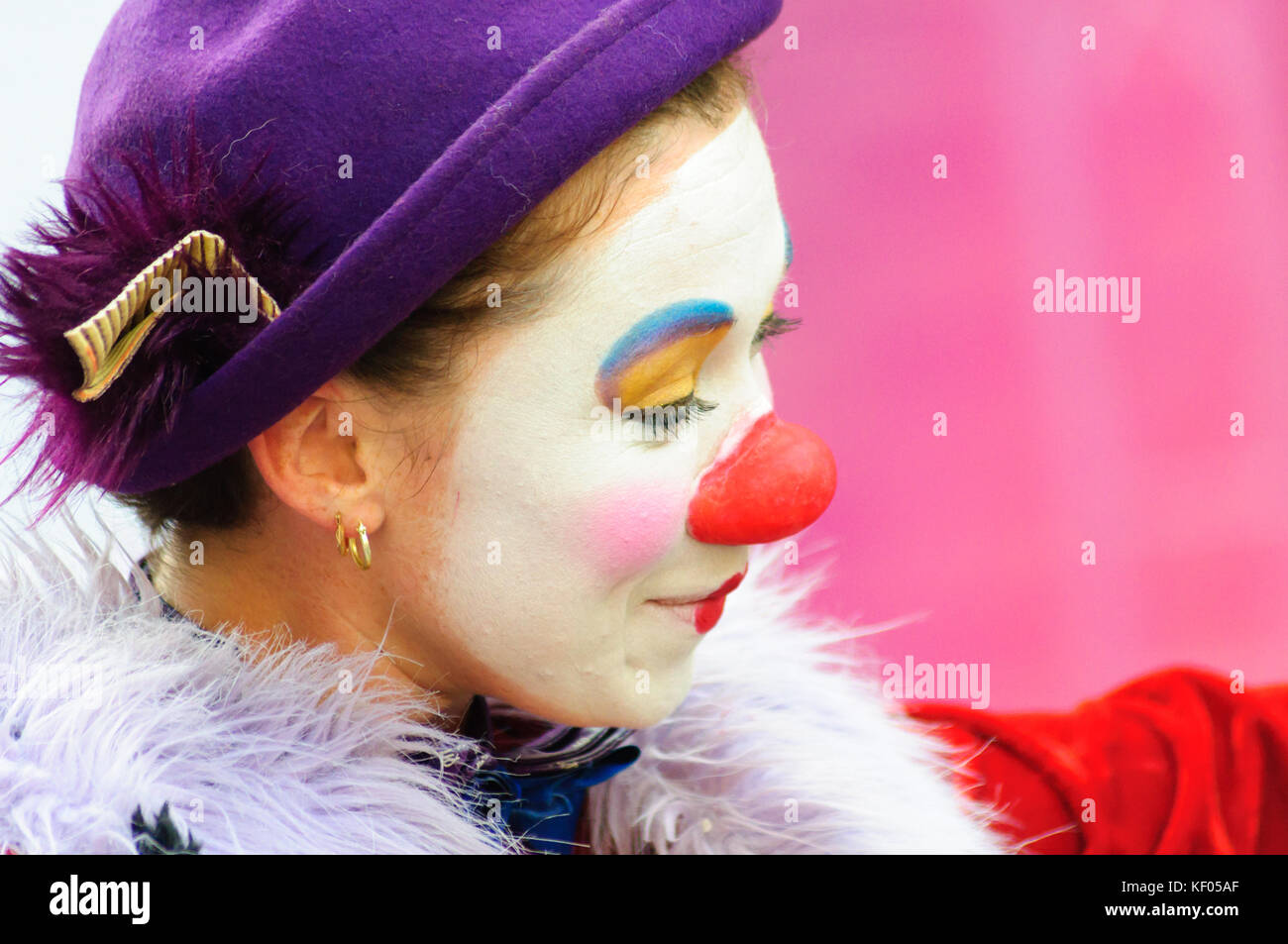 Female mime artist with painted face and costume performs on the high ...