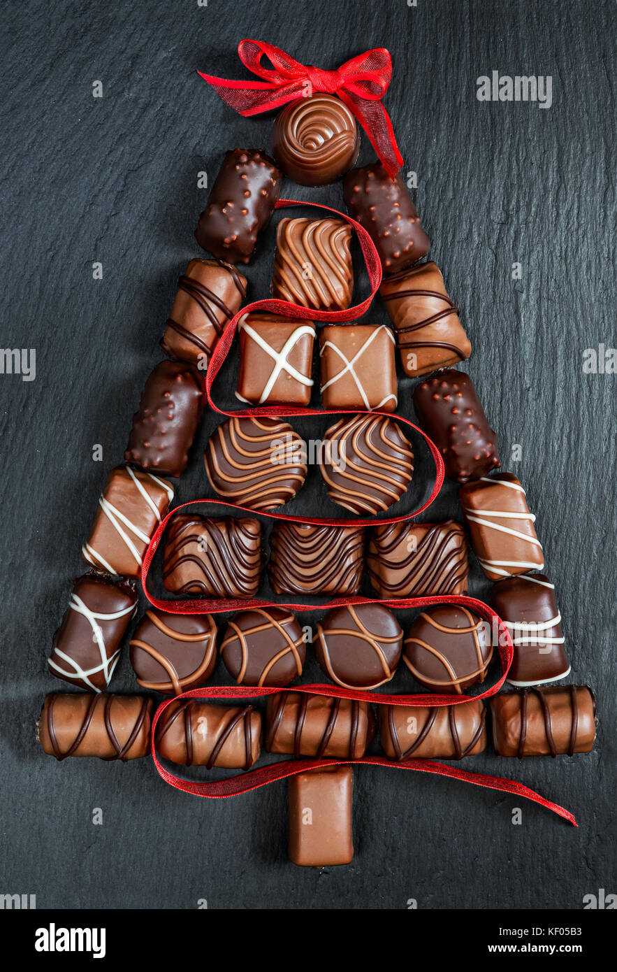 Chocolate pralines Christmas tree on stone black table Stock Photo - Alamy