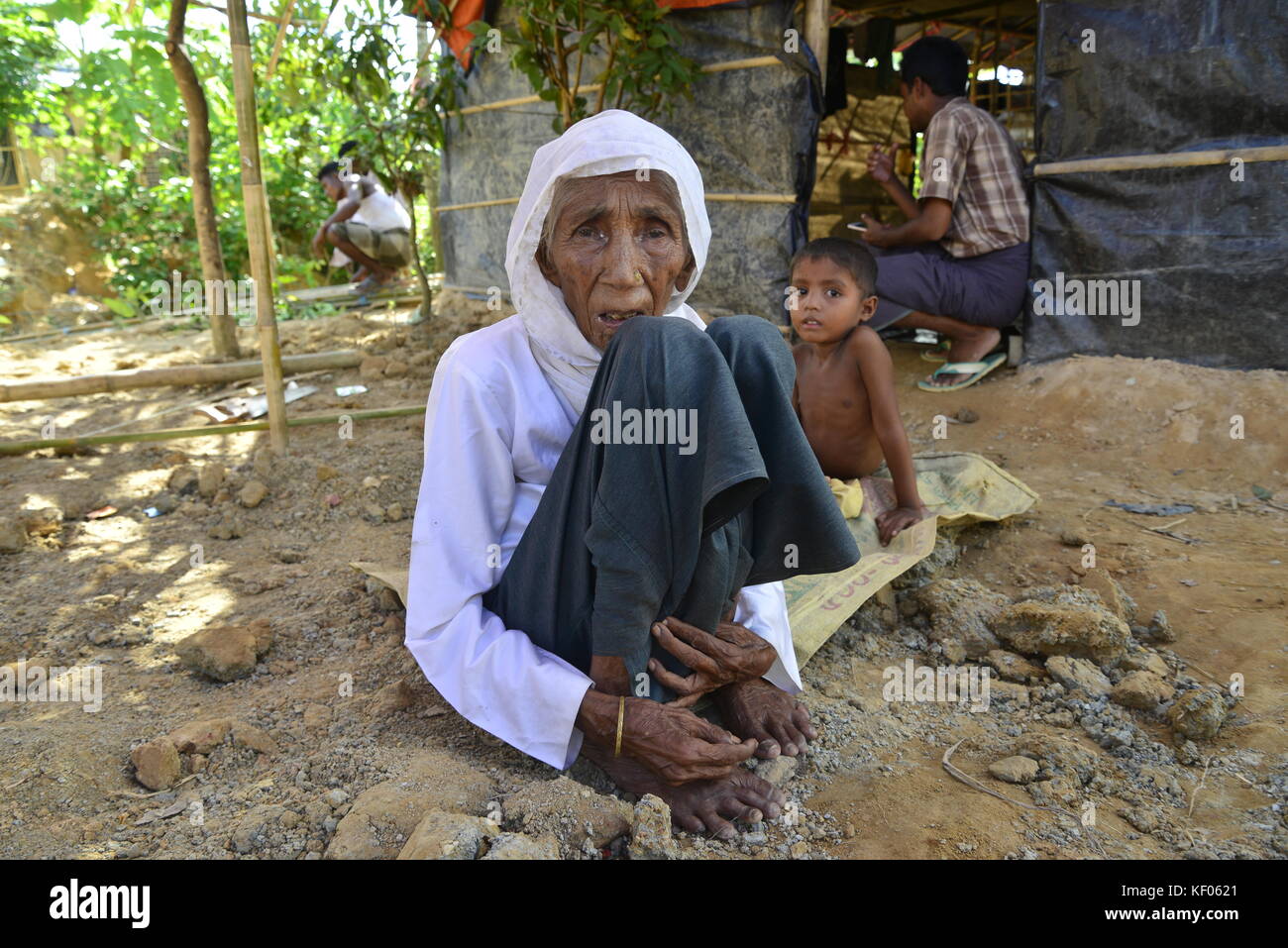 A Rohingya refugee family member sits in their house at the palongkhali ...