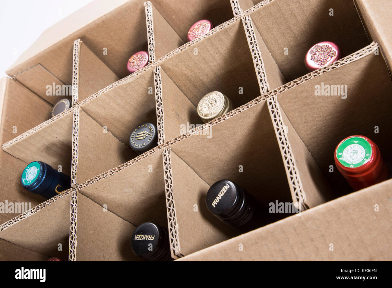 A 12 bottle brown cardboard wine box with bottles photographed on a ...