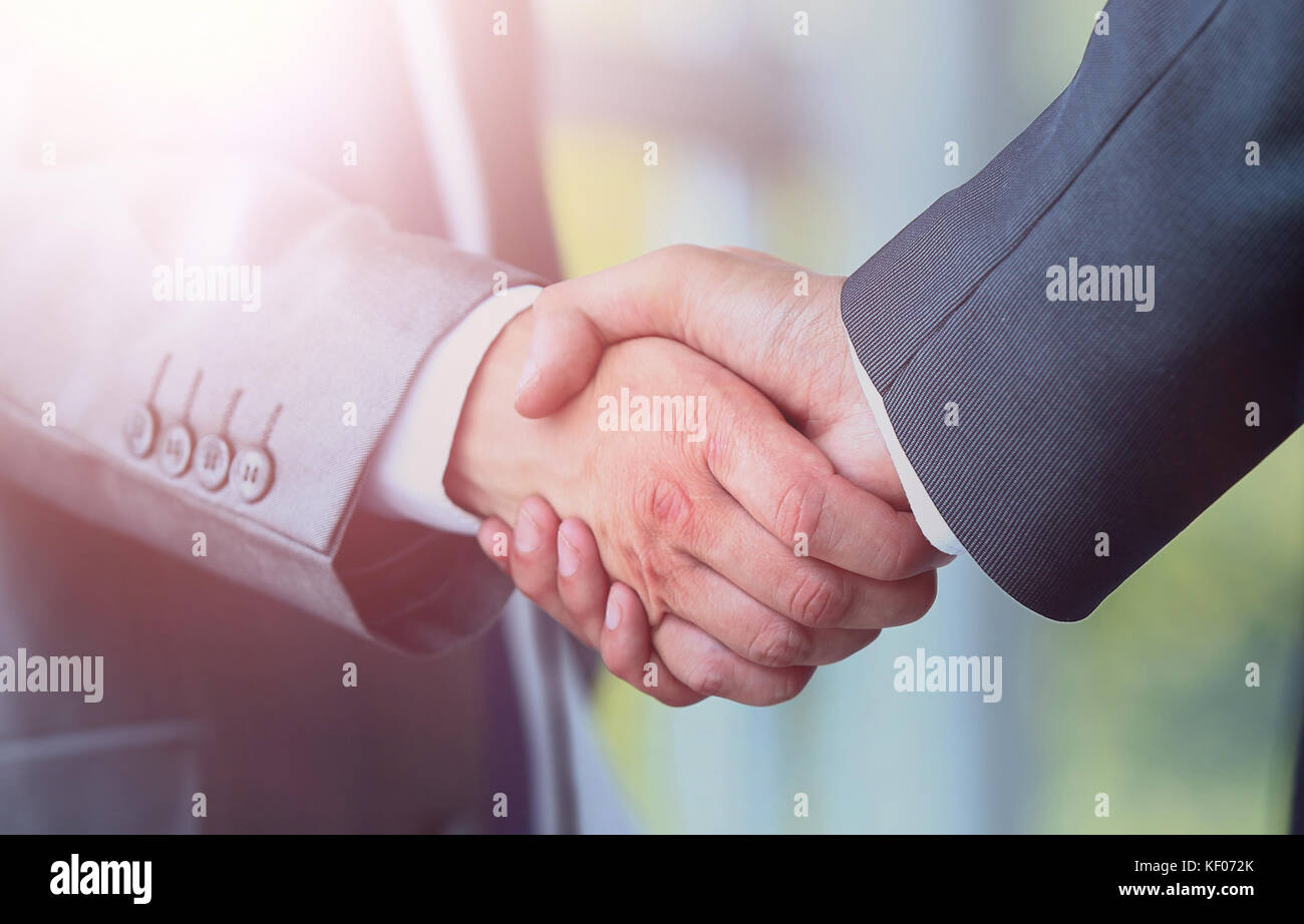 Two businessman shaking hands Stock Photo - Alamy