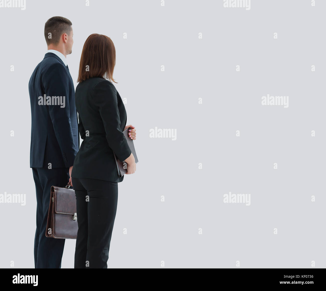 The back of twobusiness person looking at wall Stock Photo - Alamy