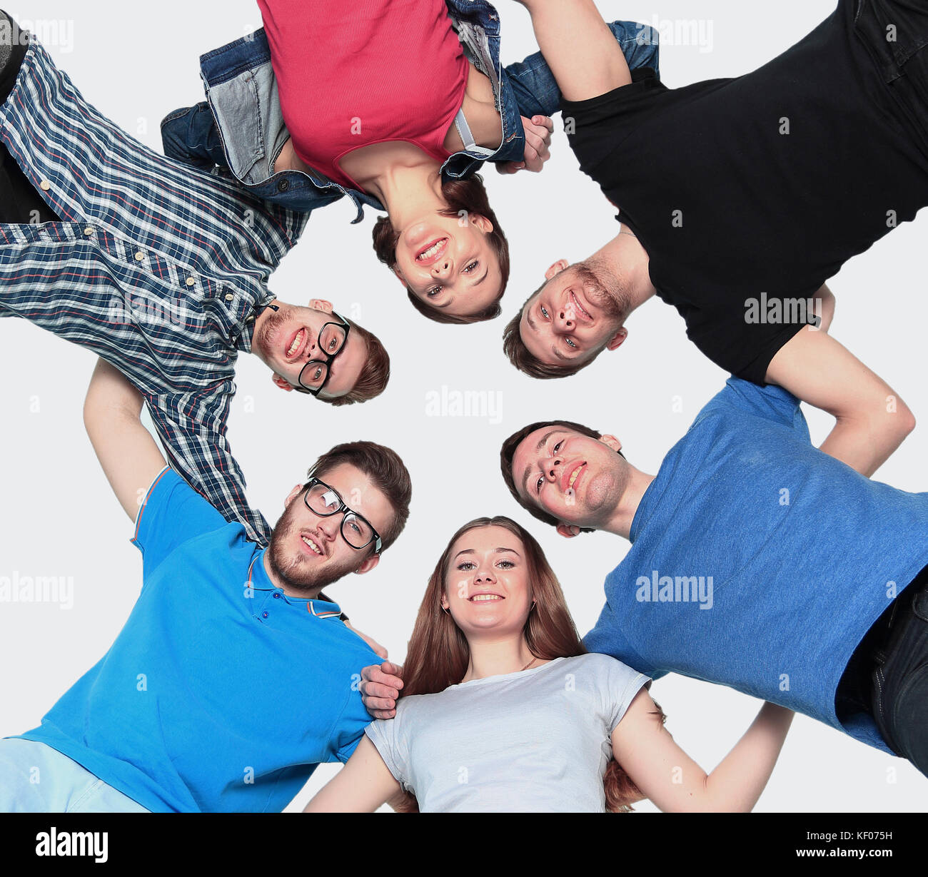 portrait of confident college students forming huddle over white ...