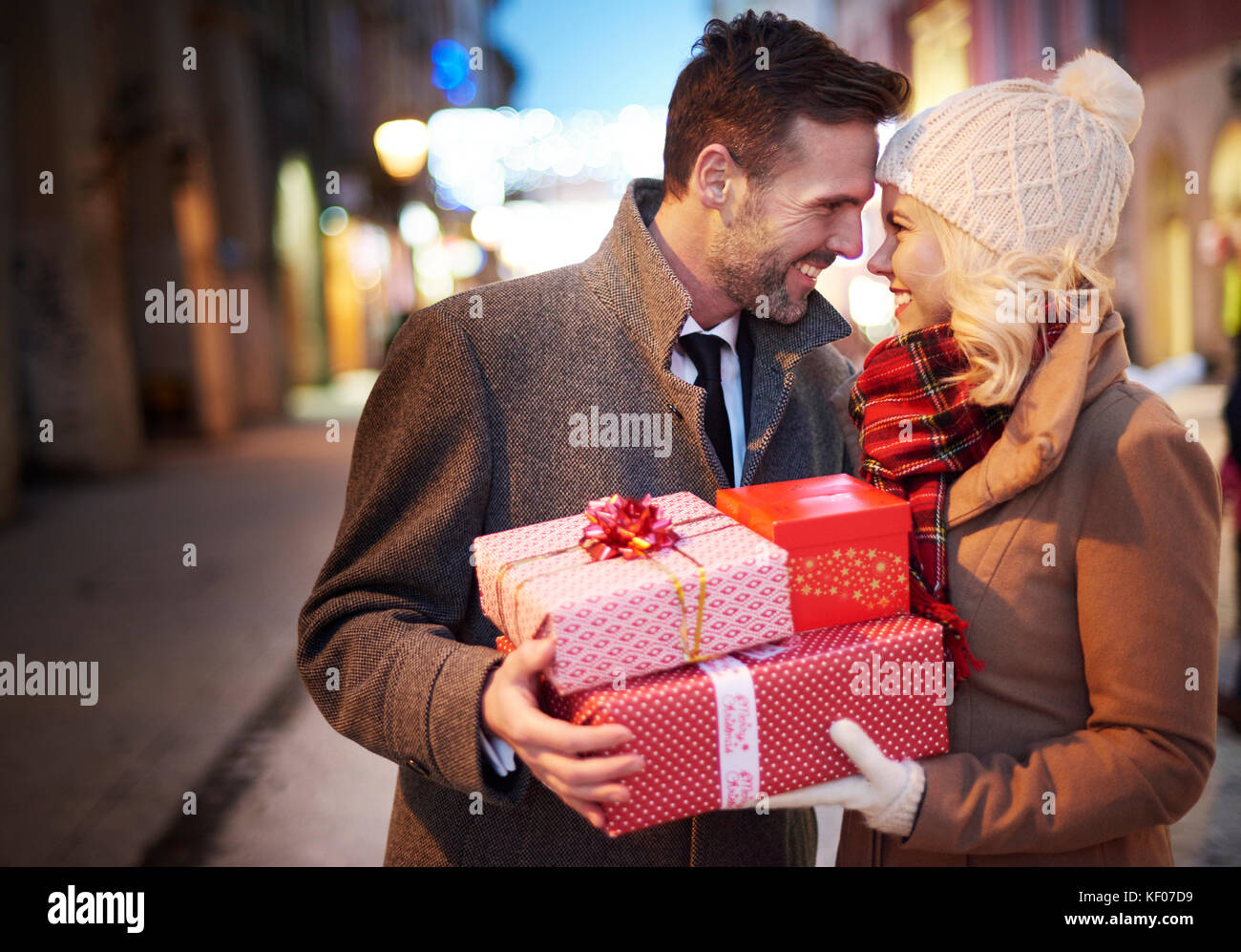 Affectionate couple with stack of presents Stock Photo - Alamy