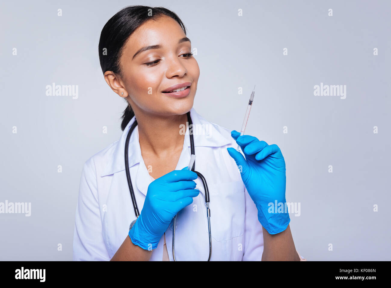 Pleasant female doctor holding syringe Stock Photo - Alamy