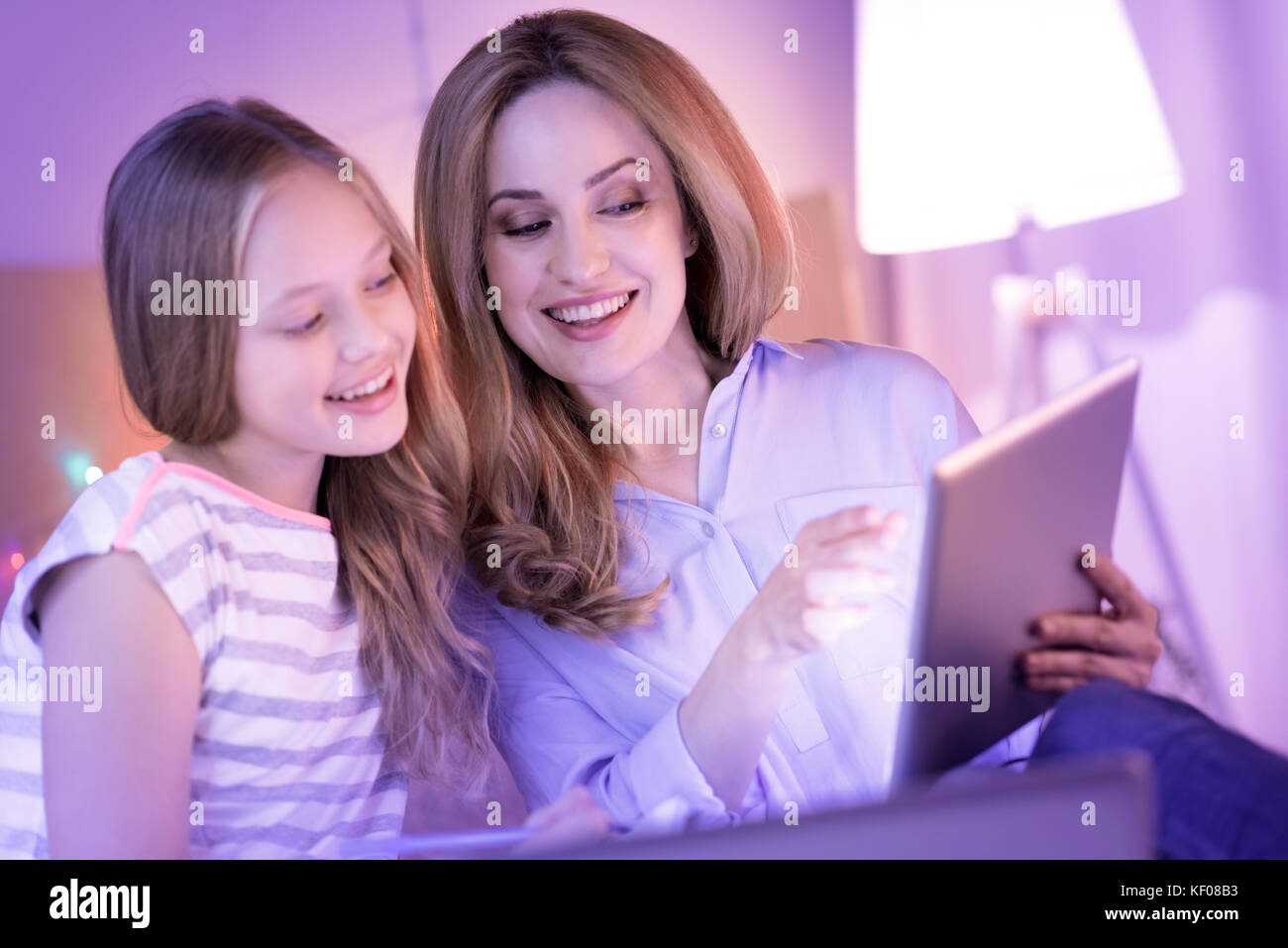 Smiling mummy and daughter relaxing together Stock Photo - Alamy