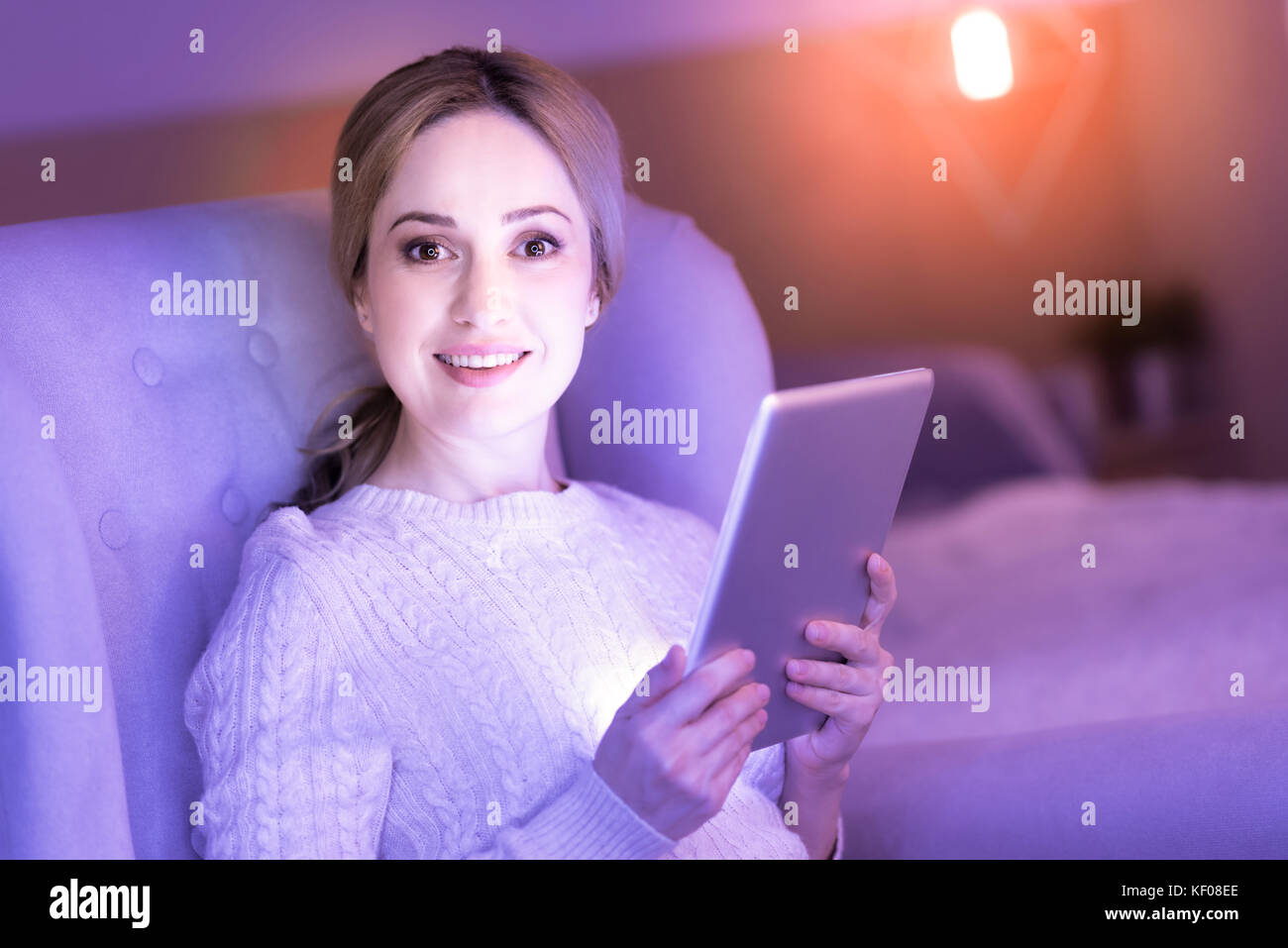 Glad young lady holding the tablet Stock Photo - Alamy