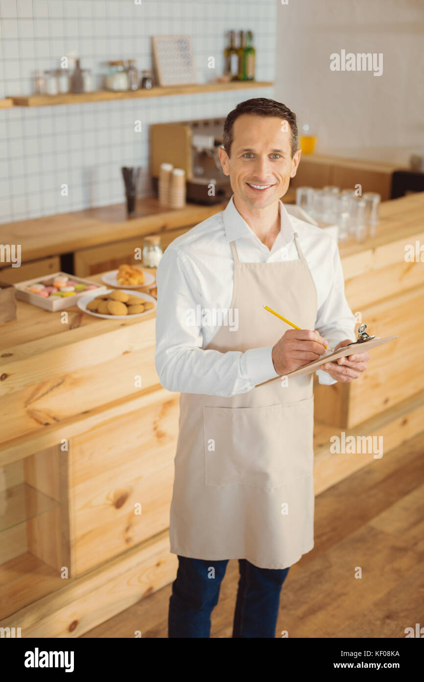 Delighted positive man working at the bakery Stock Photo - Alamy