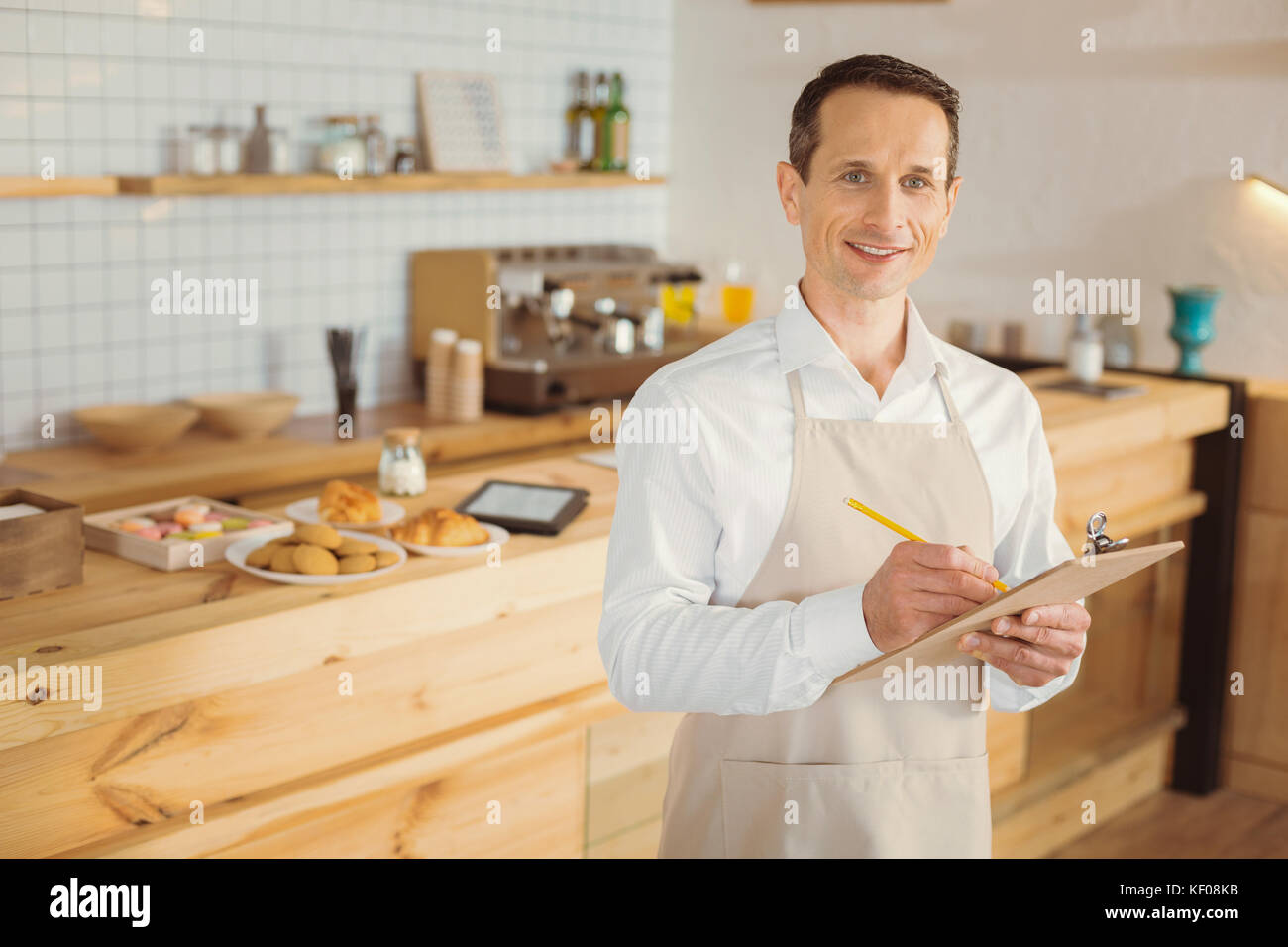 Happy positive man writing Stock Photo - Alamy