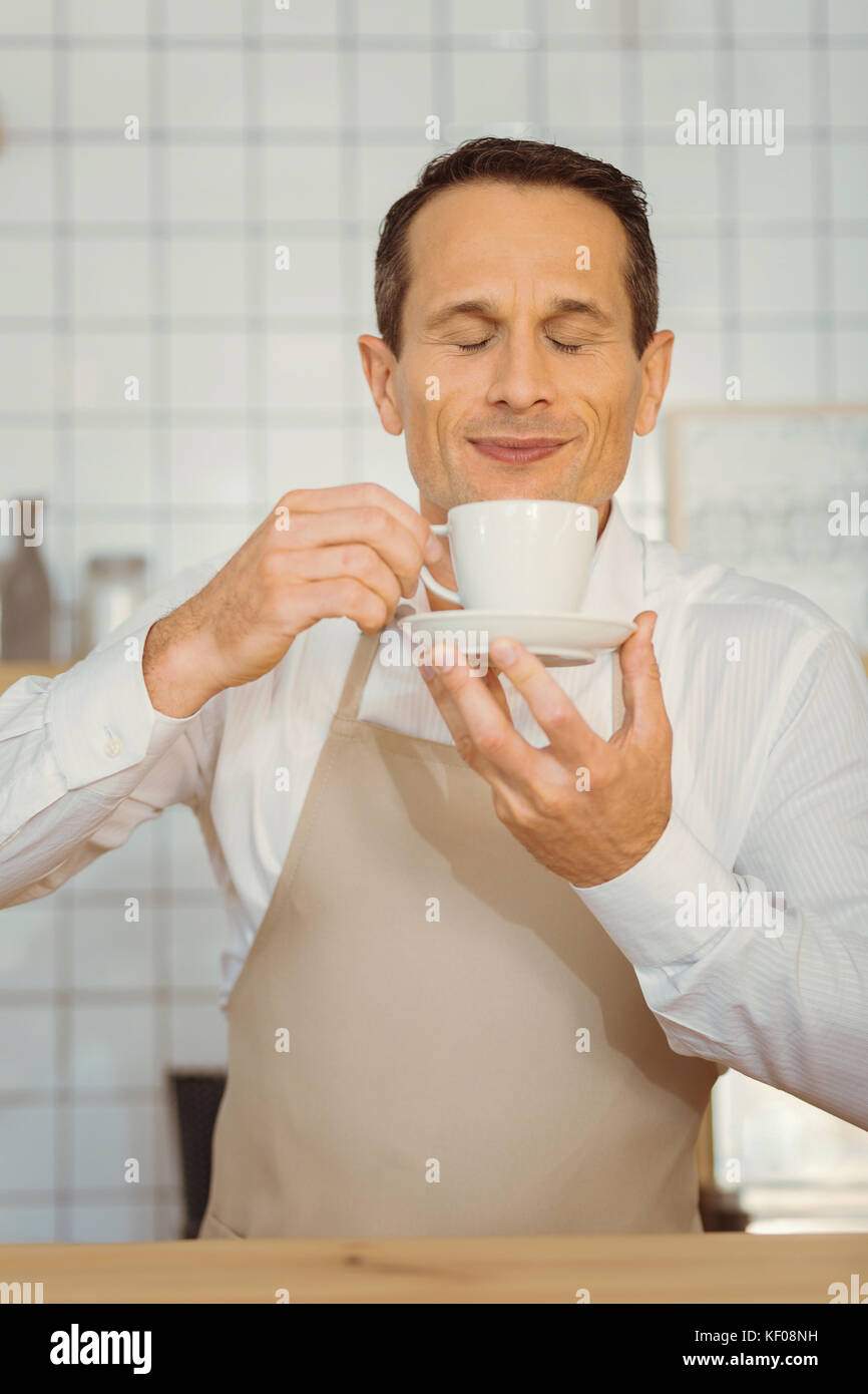 Happy cheerful man enjoying the smell of coffee Stock Photo - Alamy